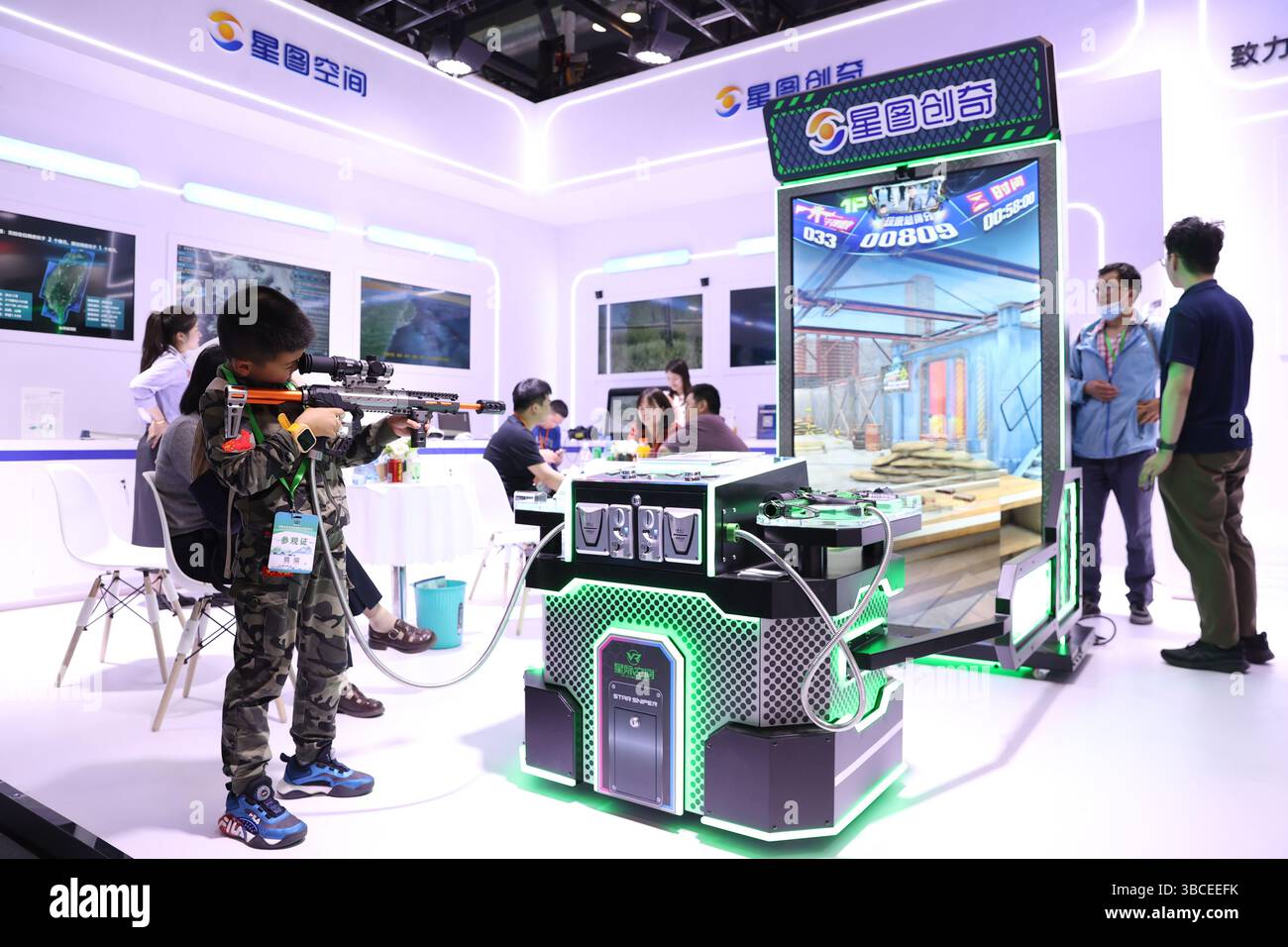 A boy tries out the shooting games. Beijing,China.15th May 2025. The ...