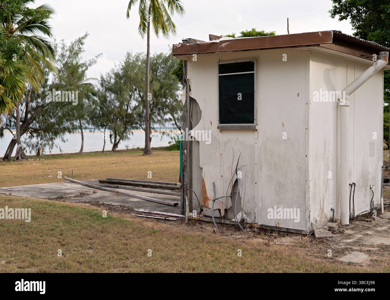 Weather-worn shack by the ocean with damage and debris Stock Photo - Alamy