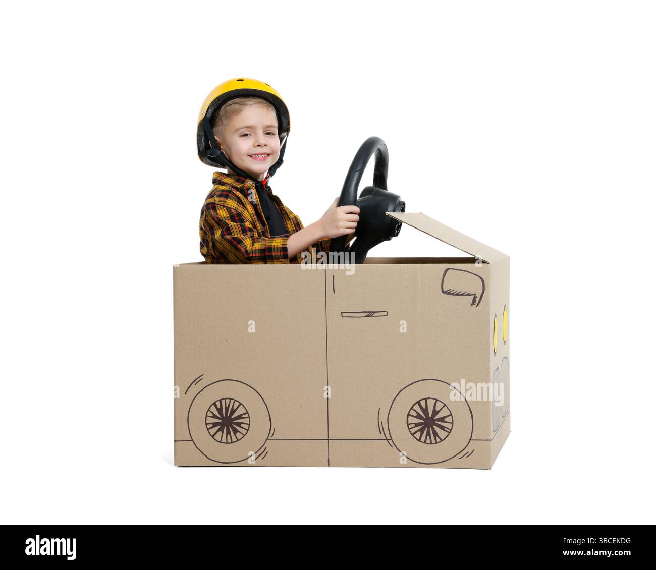 Little boy driving car made of cardboard on white background Stock ...