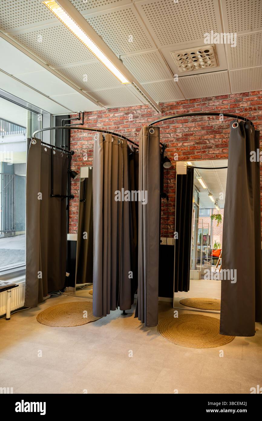 Modern fitting room with curtains and mirrors in stylish interior space ...