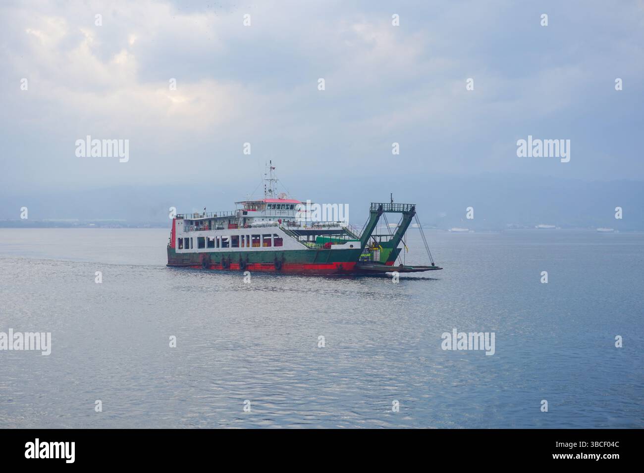 Ferry boat crossing the sea, carrying trucks cars and passengers, deck ...