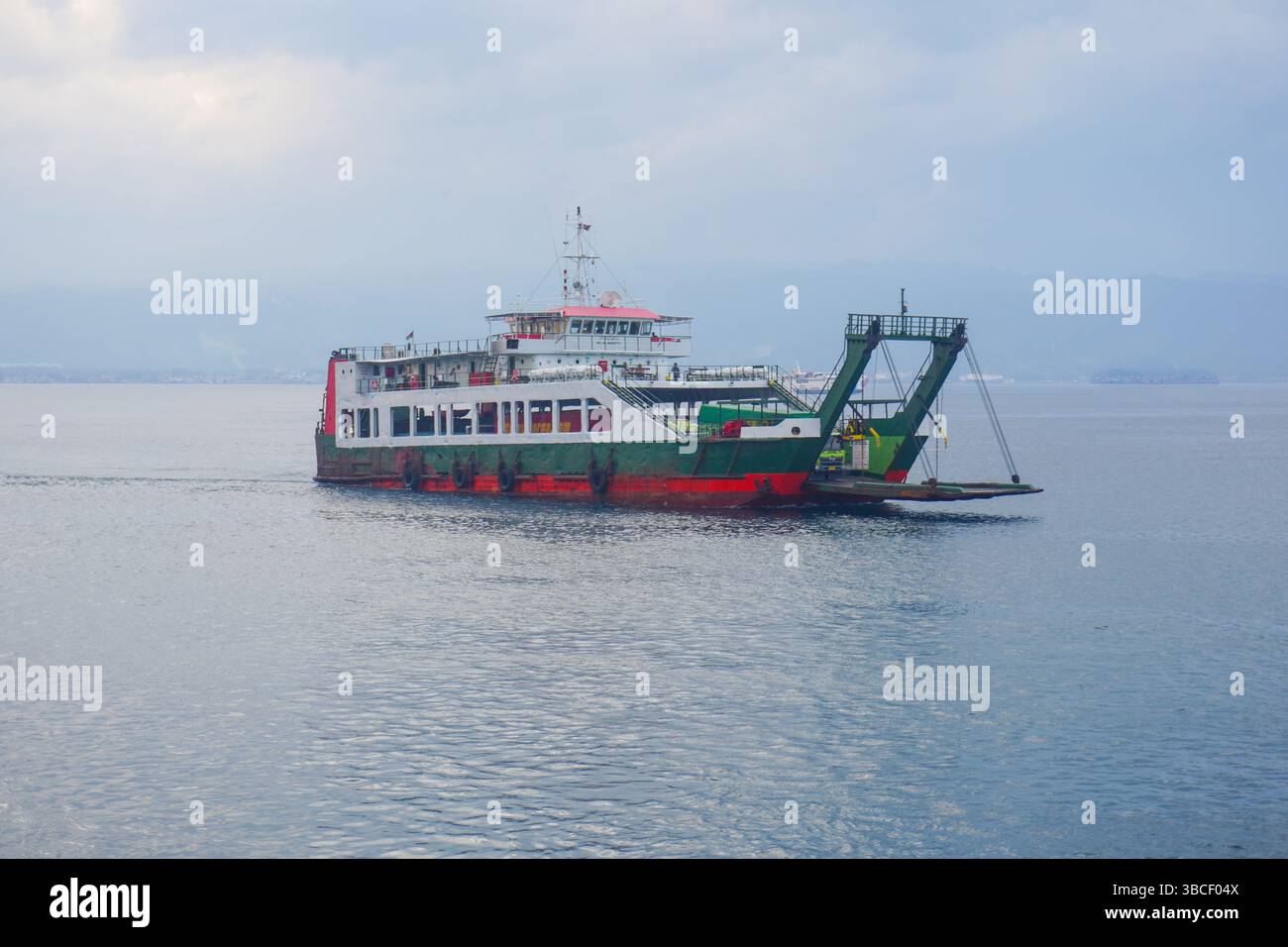 Ferry boat crossing the sea, carrying trucks cars and passengers, deck ...