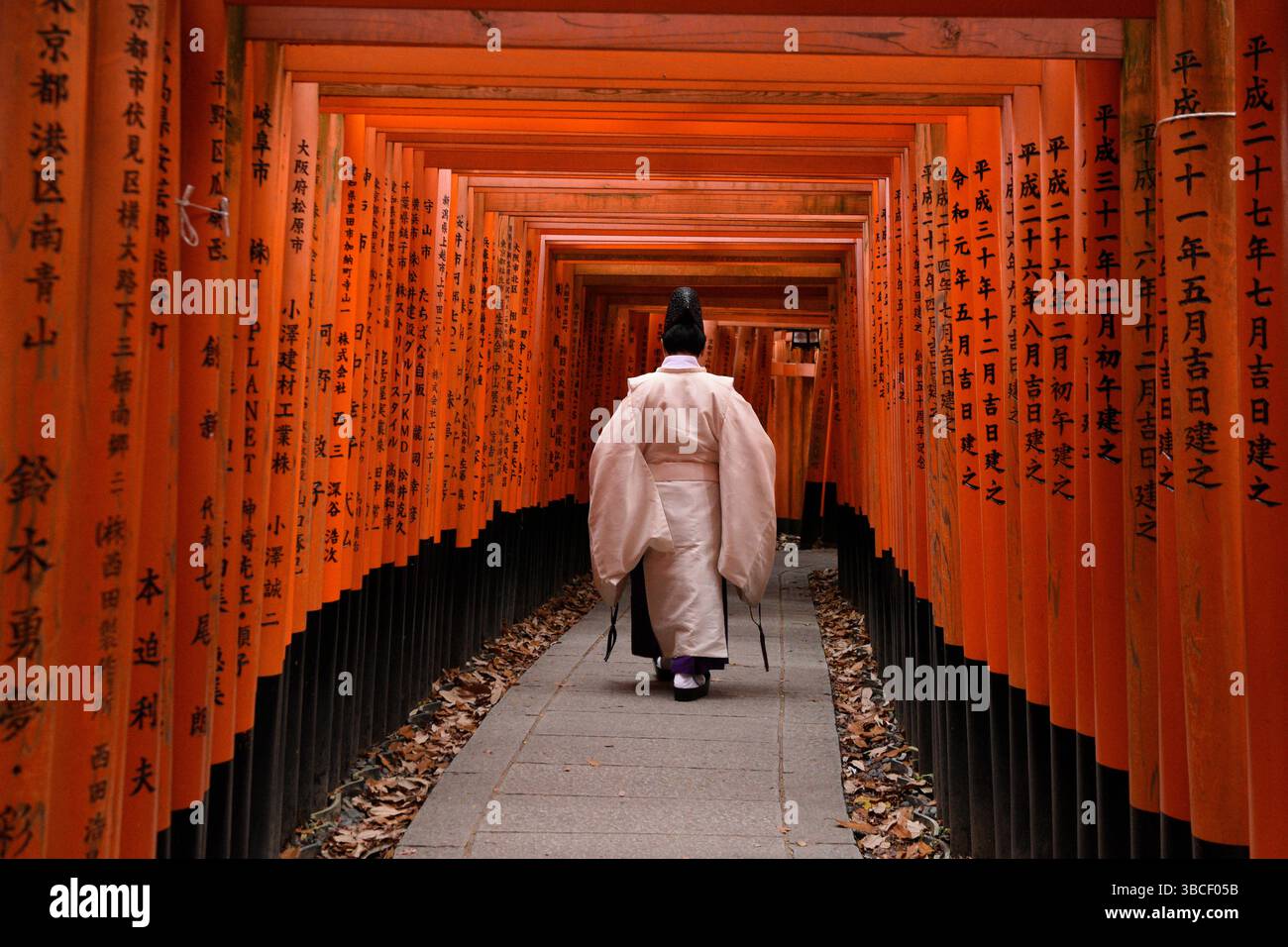 Japanese Priest walking up hill in Kyoto most famous shrine, Fushimi ...