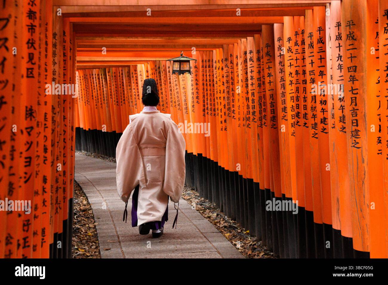 Japanese Priest walking up hill in Kyoto most famous shrine, Fushimi ...