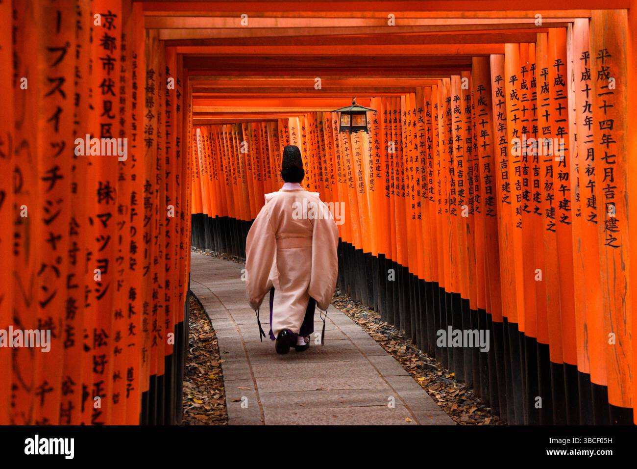 Japanese Priest walking up hill in Kyoto most famous shrine, Fushimi ...