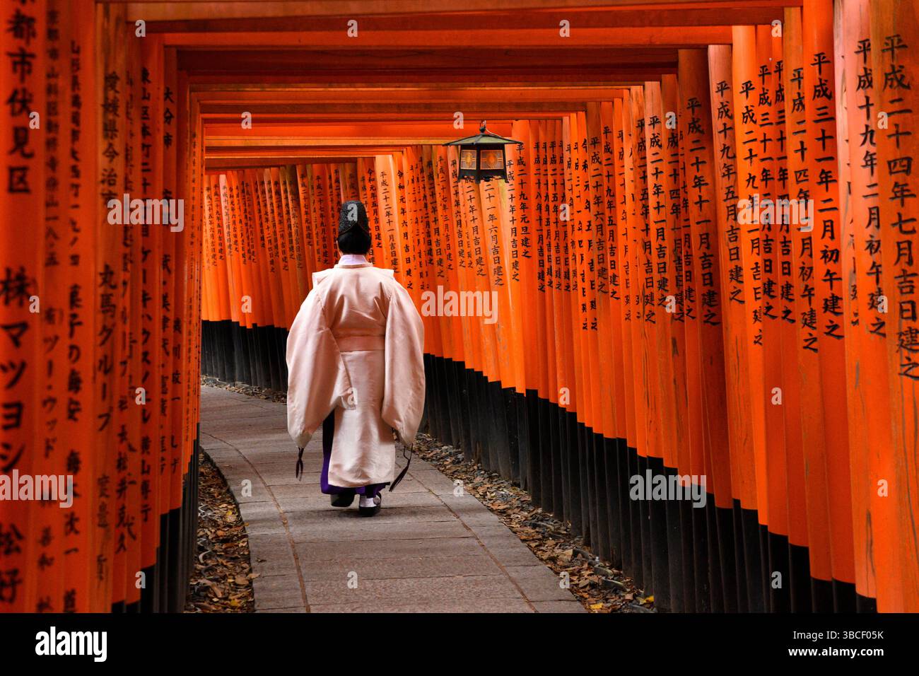 Japanese Priest walking up hill in Kyoto most famous shrine, Fushimi ...