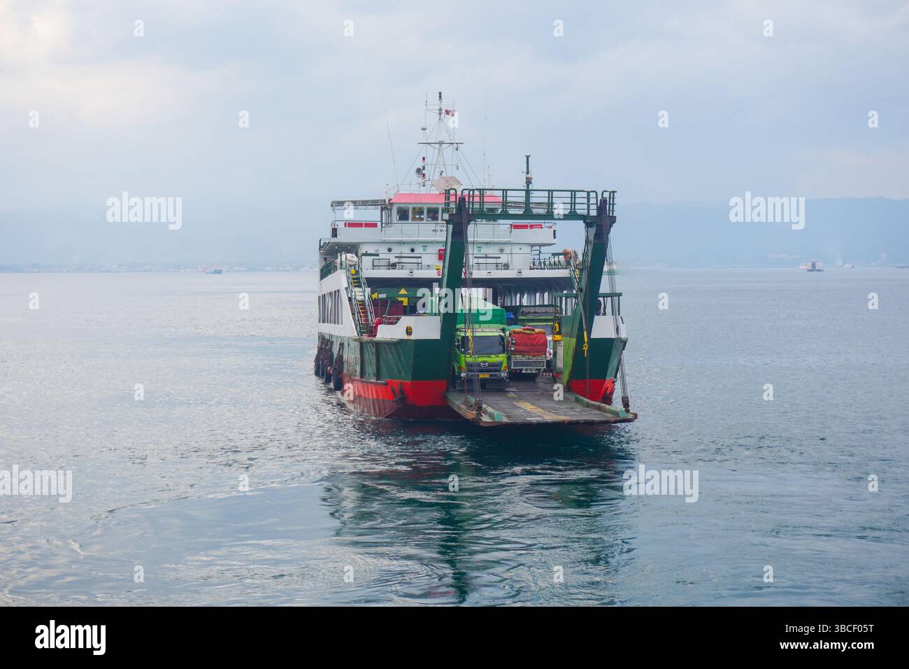 Ferry boat crossing the sea, carrying trucks cars and passengers, deck ...