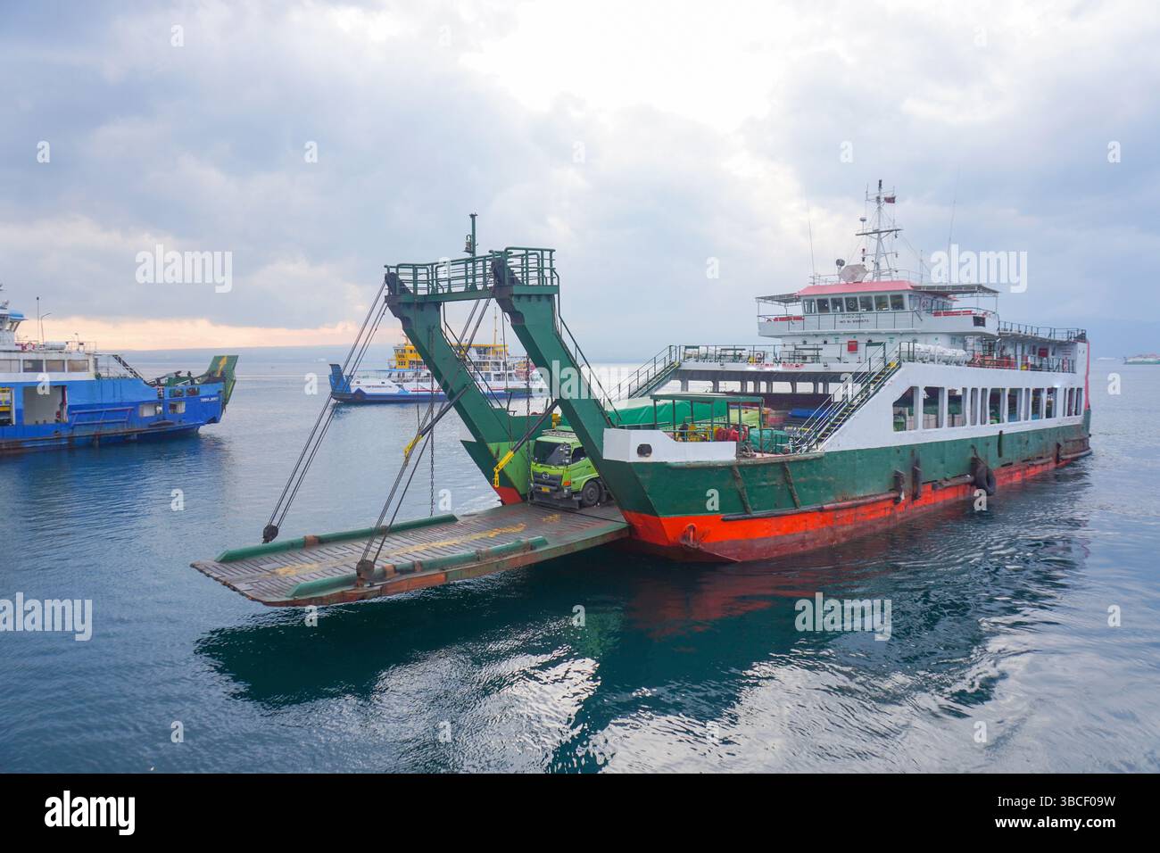Ferry boat crossing the sea, carrying trucks cars and passengers, deck ...