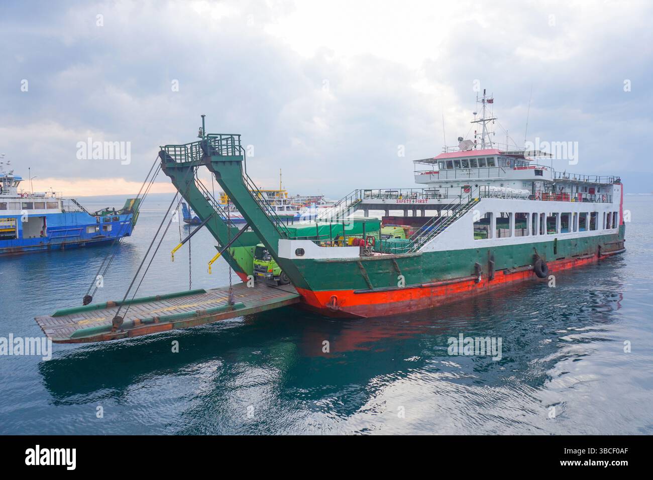 Ferry boat crossing the sea, carrying trucks cars and passengers, deck ...