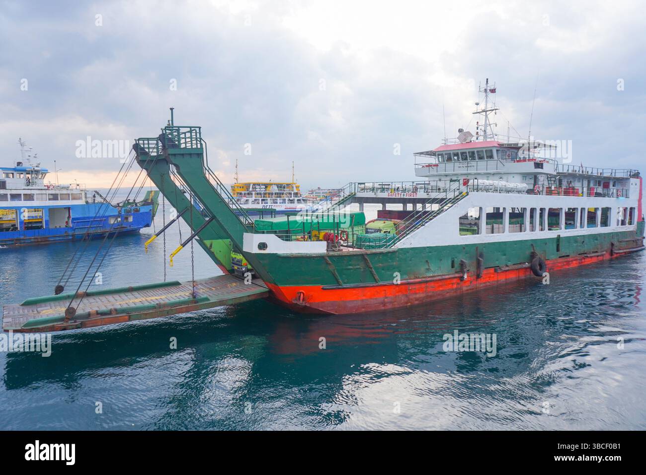 Ferry boat crossing the sea, carrying trucks cars and passengers, deck ...