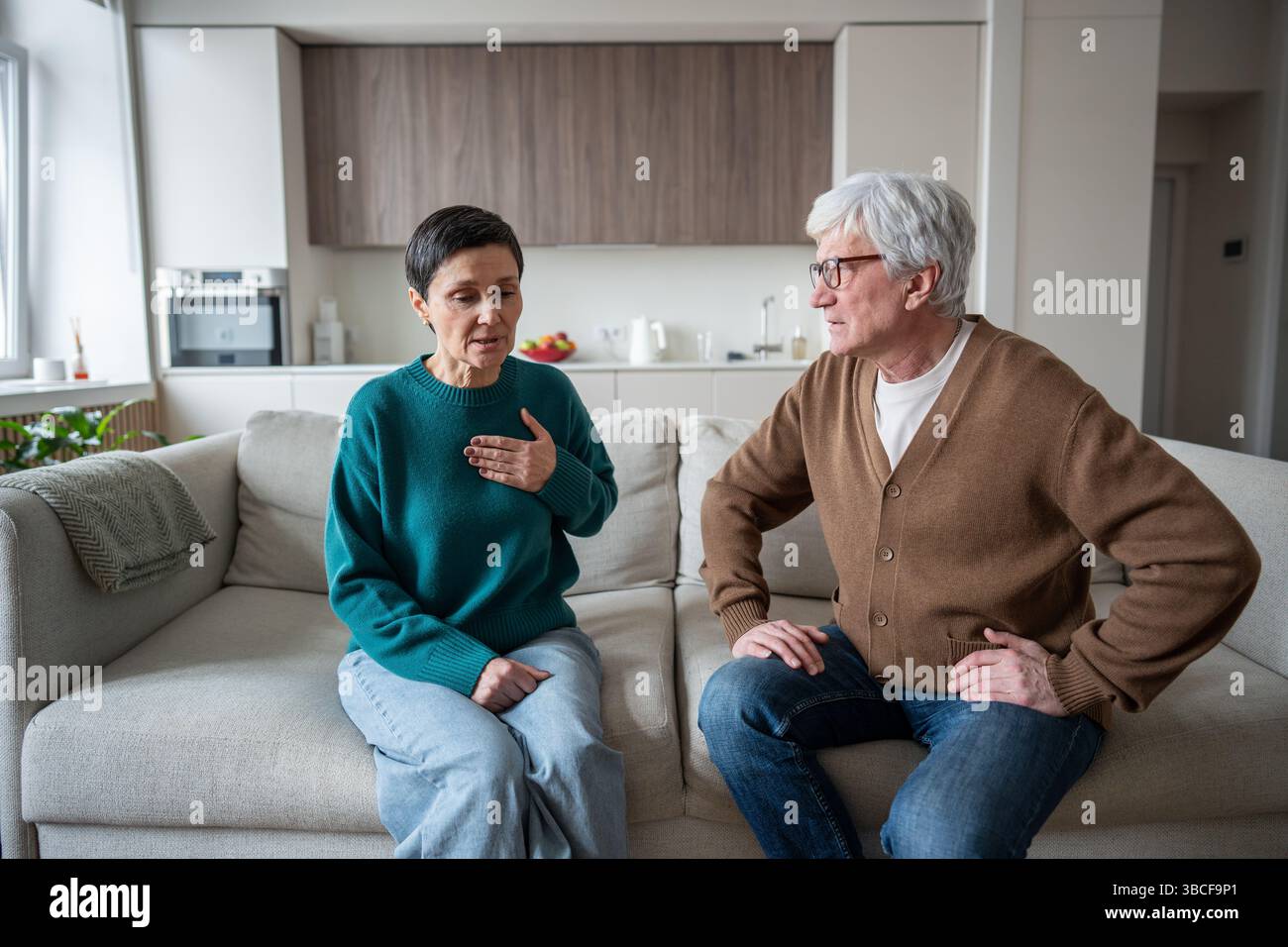 Mature woman in pain gasp for breath, hold chest in rising panic ...