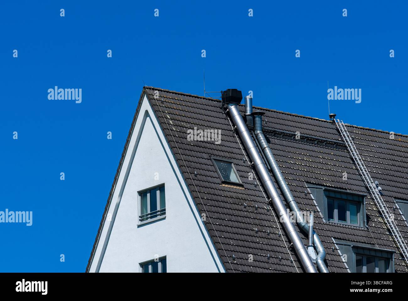 A modern residential building features a distinctive triangular roof ...