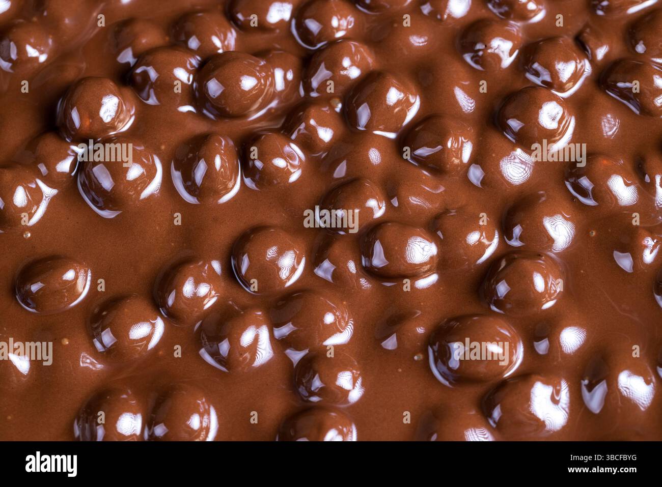 real milk chocolate while cooking with hazelnuts, a bunch of hazelnuts ...