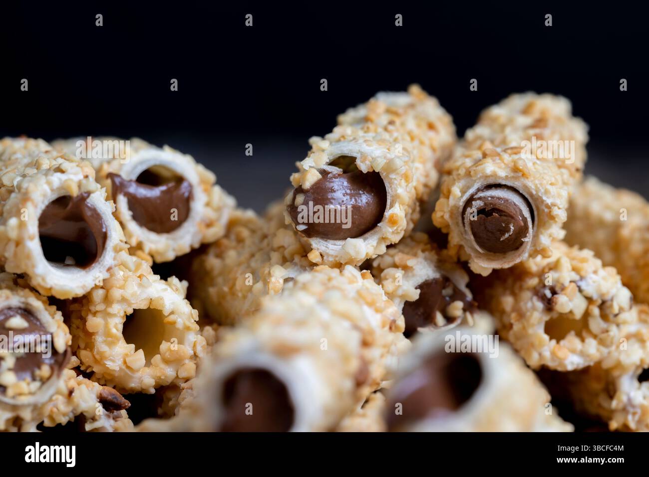 waffle tube with chocolate filling and crushed peanuts, sweet waffle ...