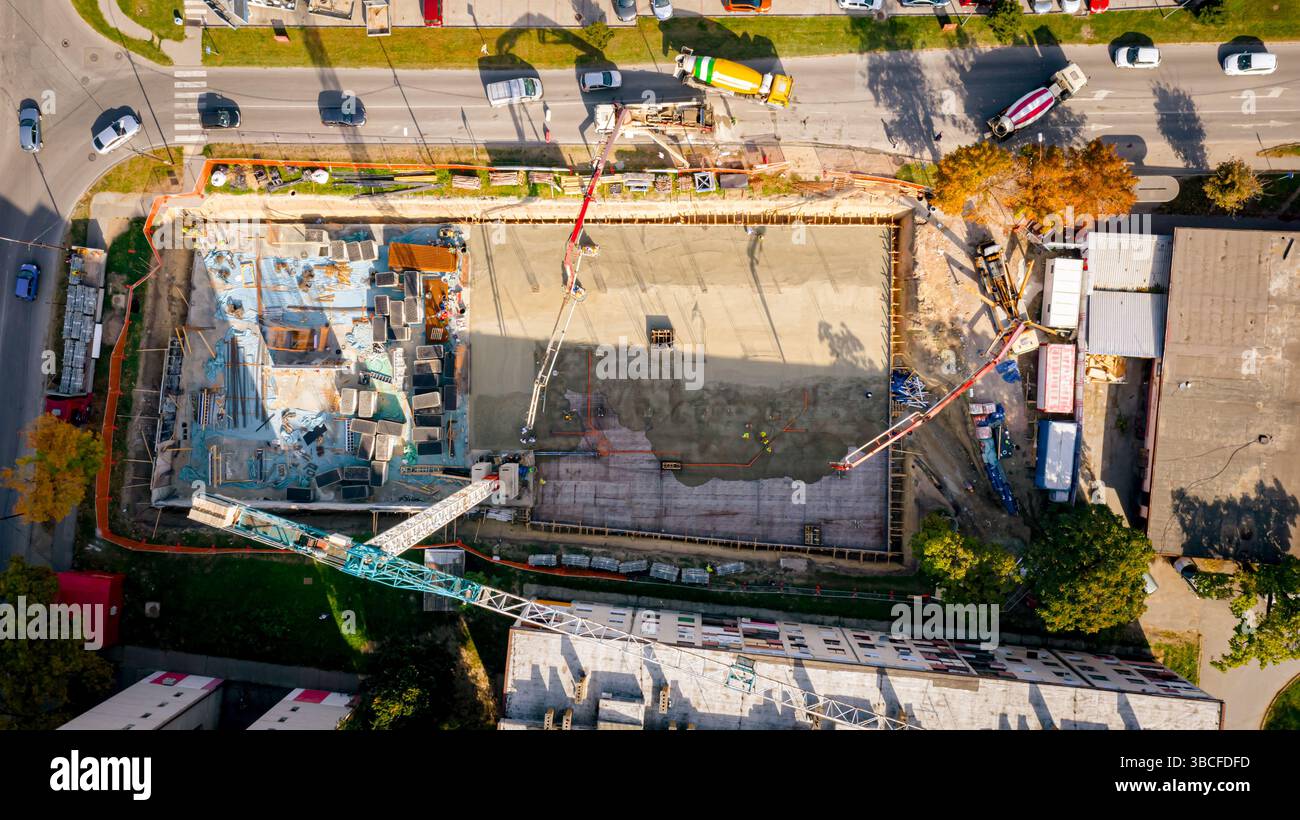 Above top view, construction site at cityscape mixer truck pour ...