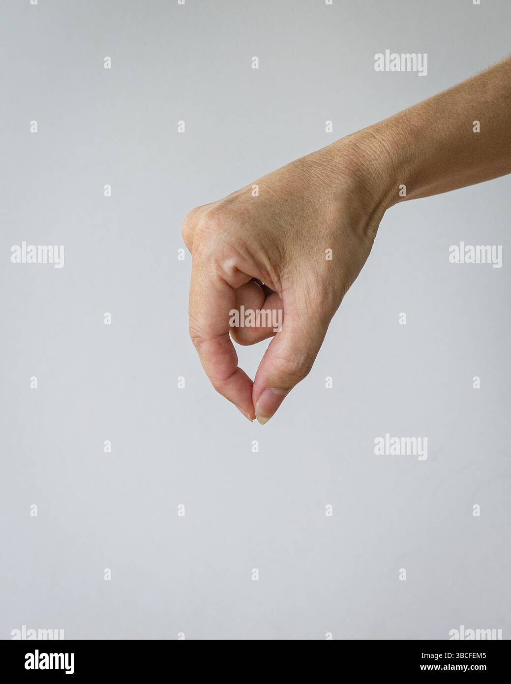 Woman hand form a gesture of reaching down to pinch something. Isolated ...