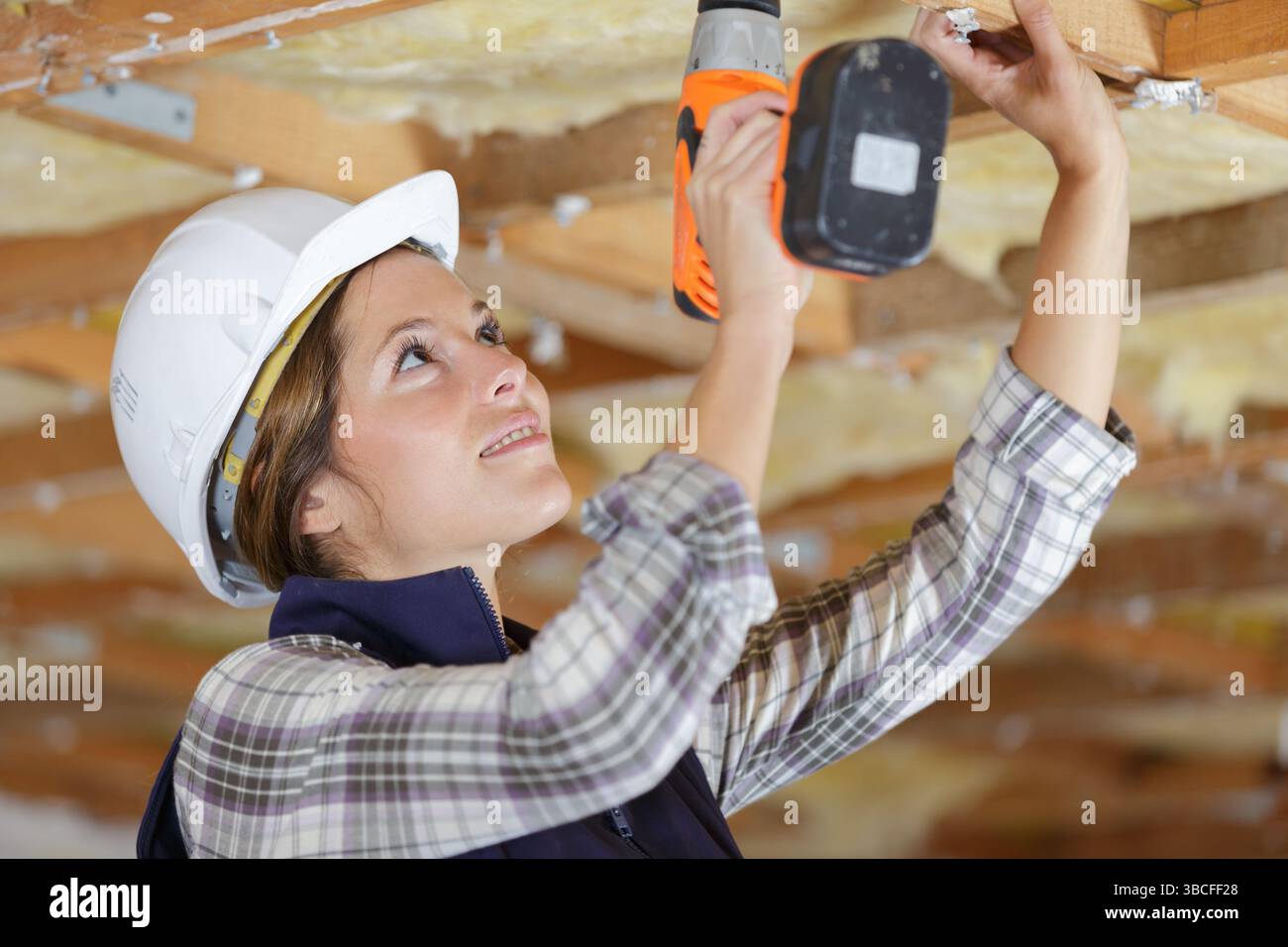 female builder using corless drill Stock Photo - Alamy