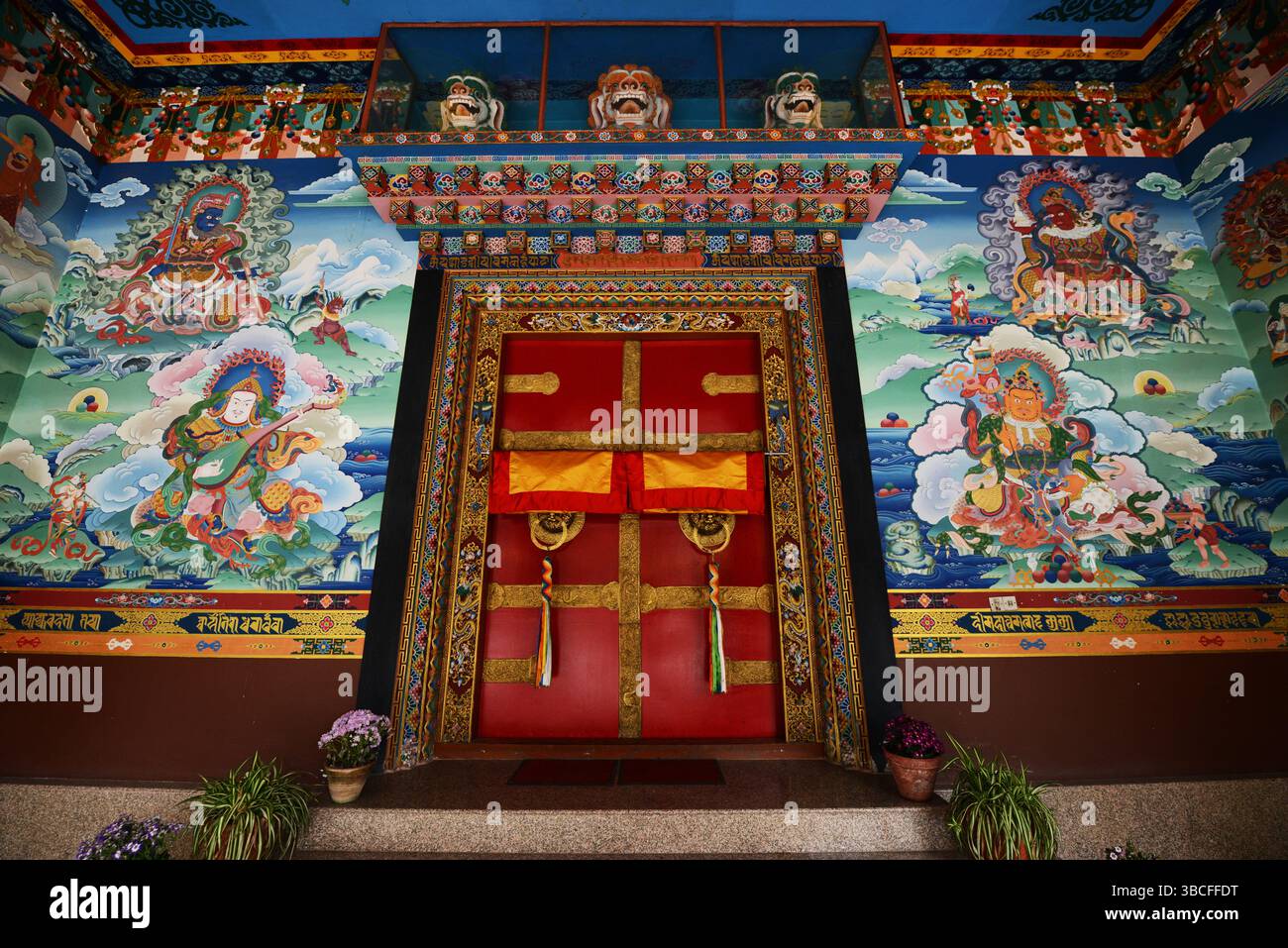 Traditional Tibetan paintings decorating the walls at the Tharlam ...