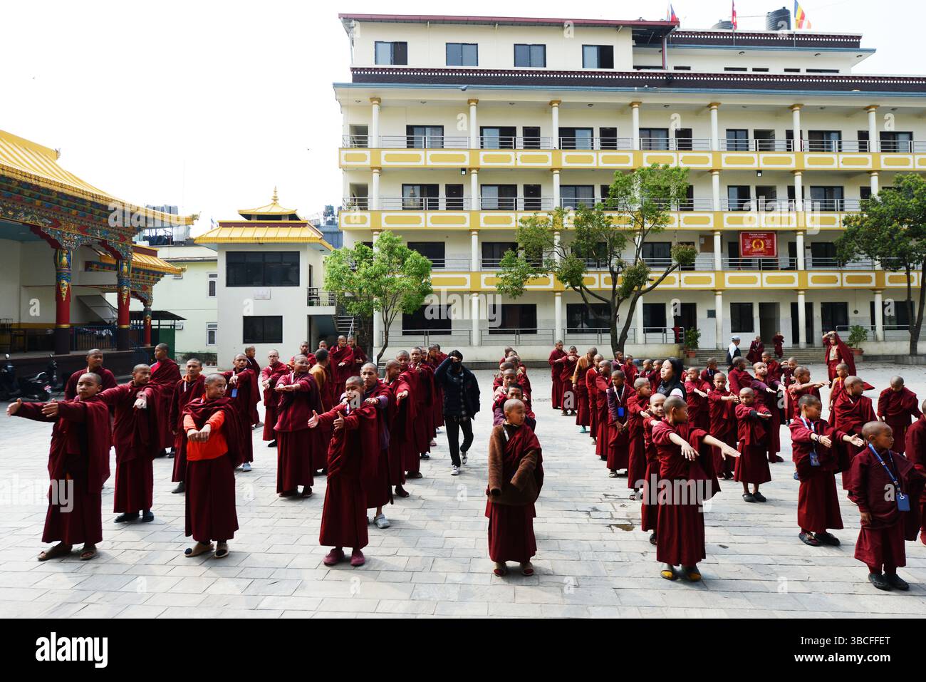 Young Tibetan Buddhist monks in an outdoor exercise with their teachers ...