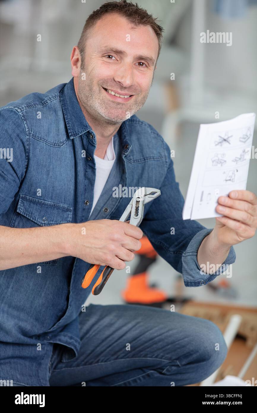 casual man reading instruction manual Stock Photo - Alamy