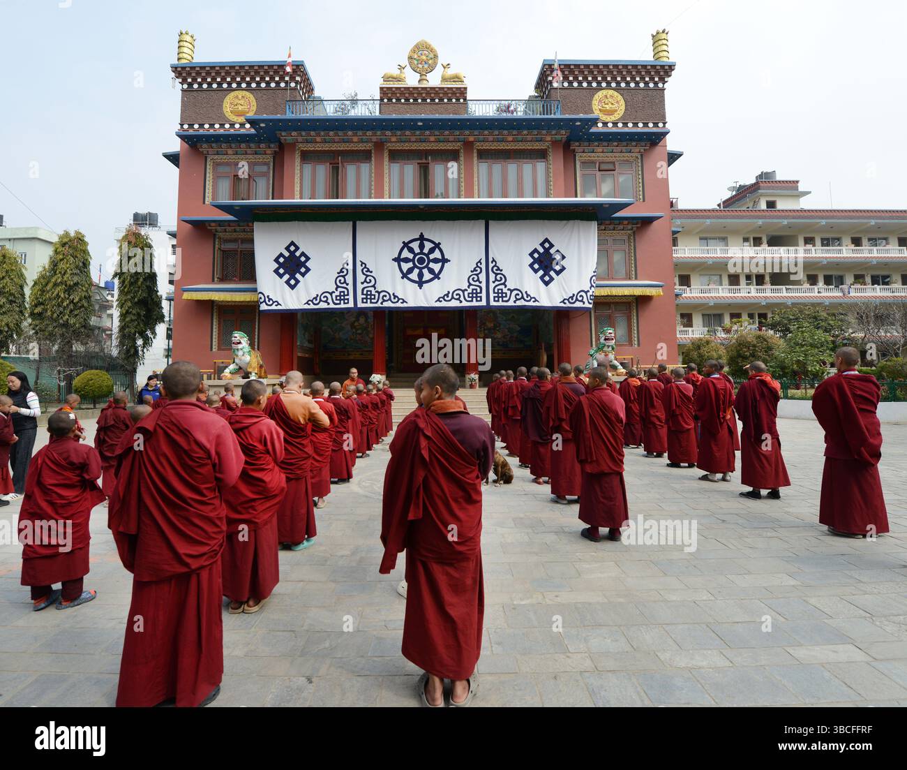 Young Tibetan Buddhist monks in an outdoor exercise with their teachers ...