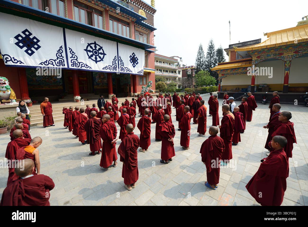 Young Tibetan Buddhist monks in an outdoor exercise with their teachers ...