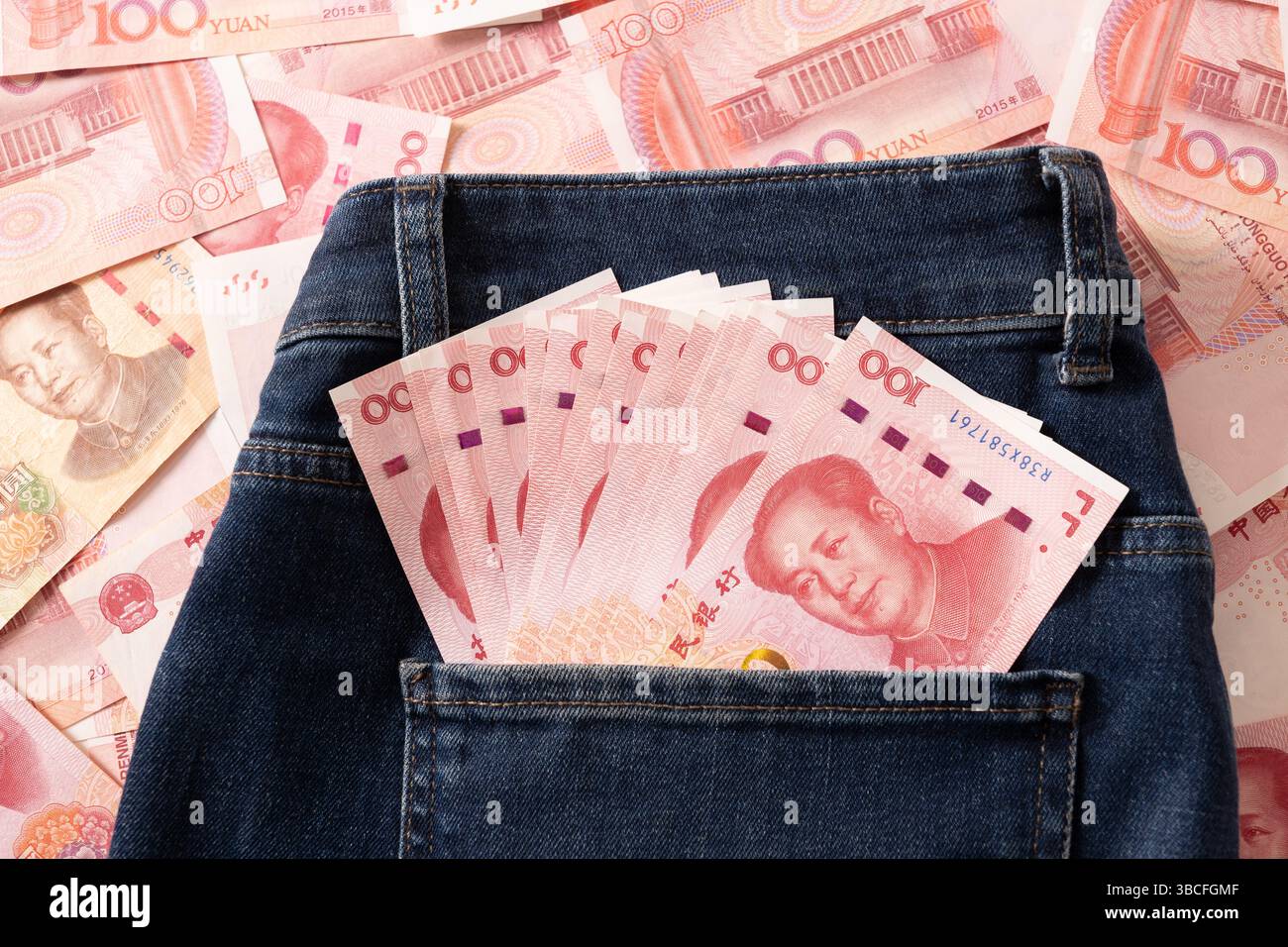 Chinese yuan 100 banknotes in jeans back pocket. Chinese paper currency ...