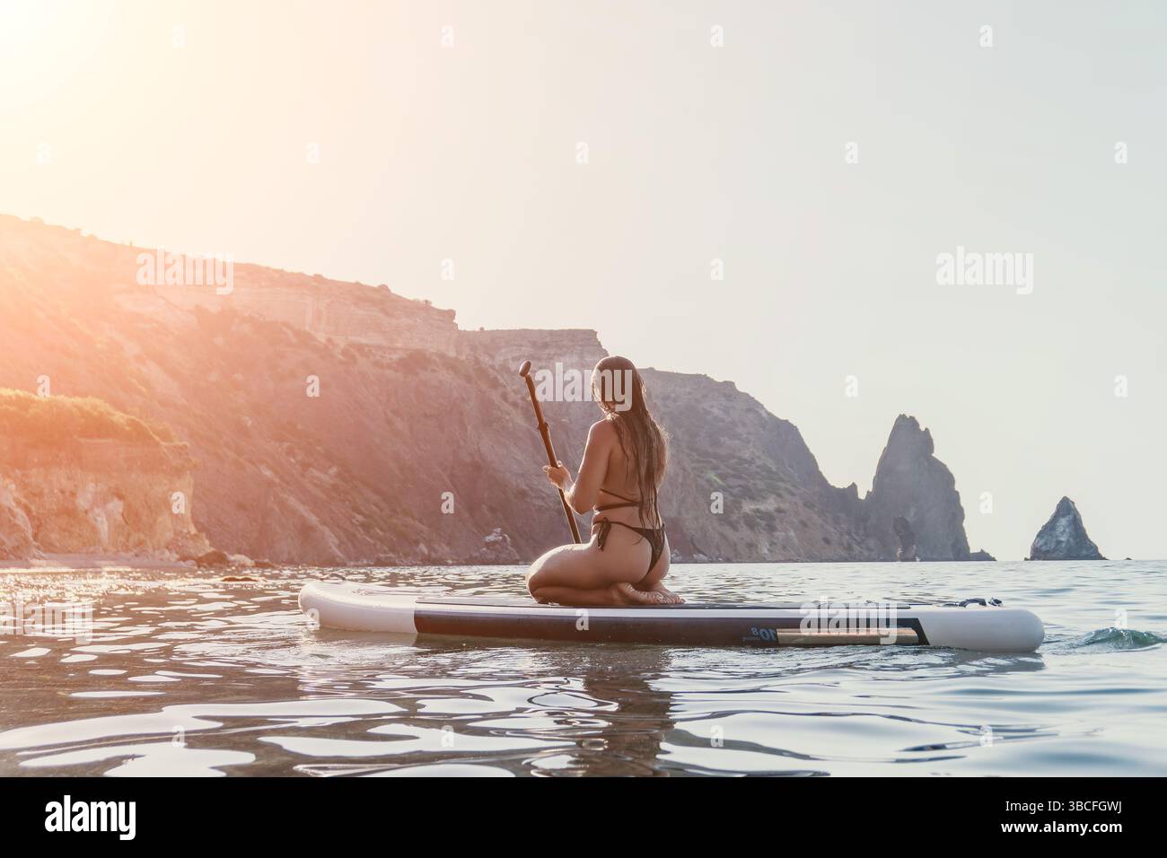 Woman Paddleboarding Ocean Cliffside Summer Activity Stock Photo - Alamy