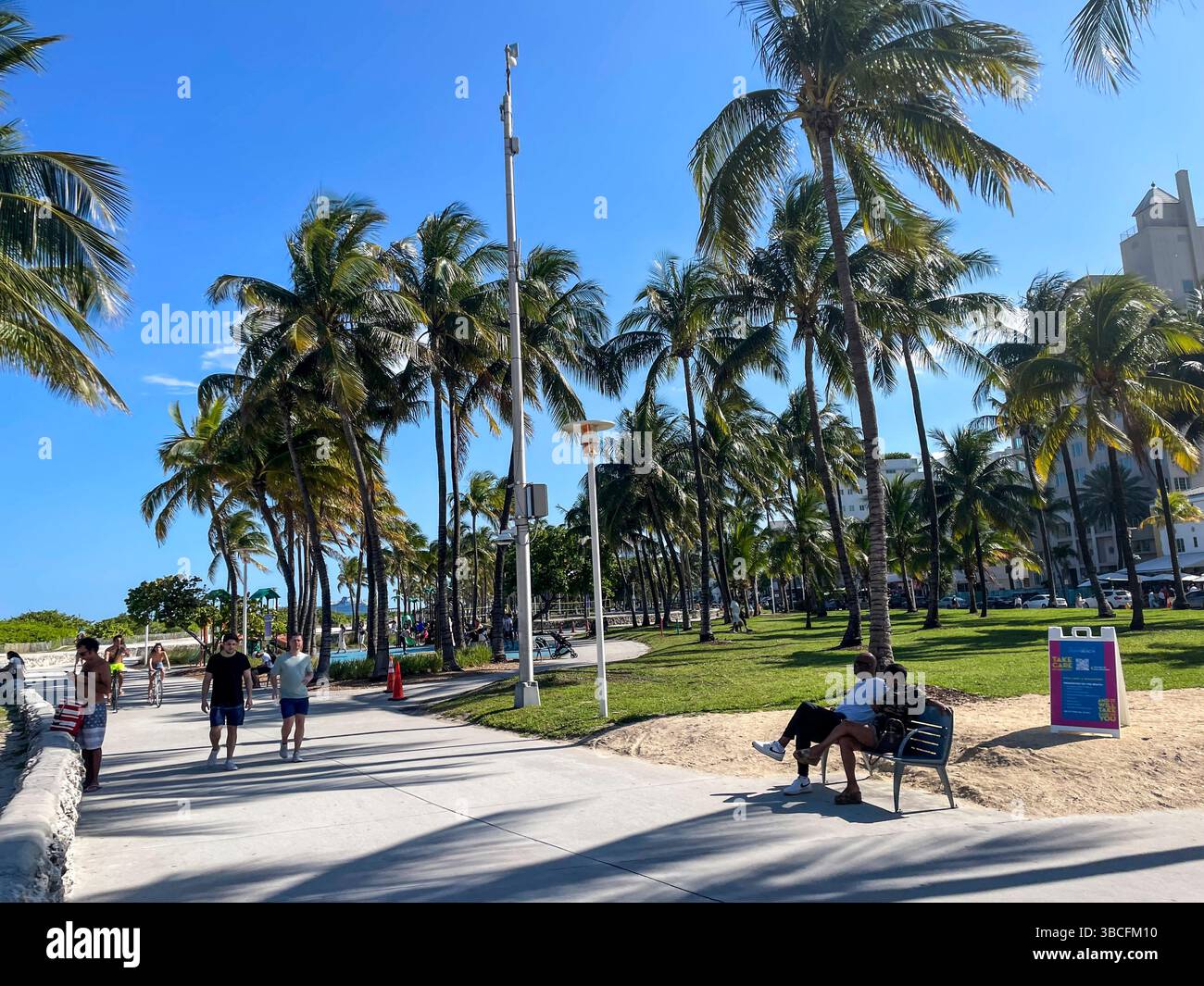 Miami, USA - May 06, 2023: Sunny day at a beachside promenade lined ...