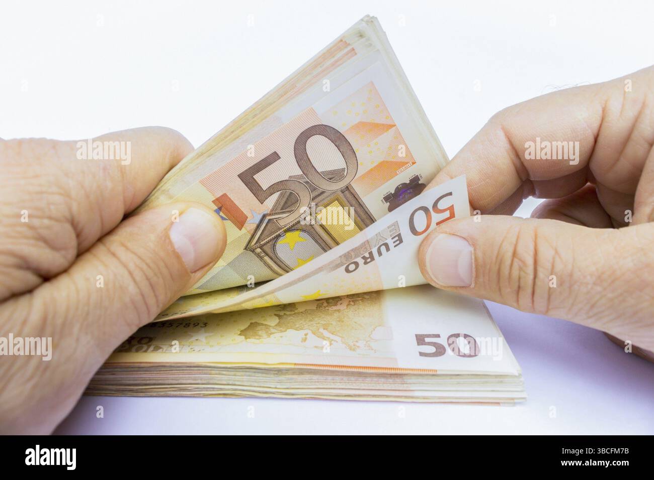 Two hands counting stack of 50 euro notes Stock Photo - Alamy