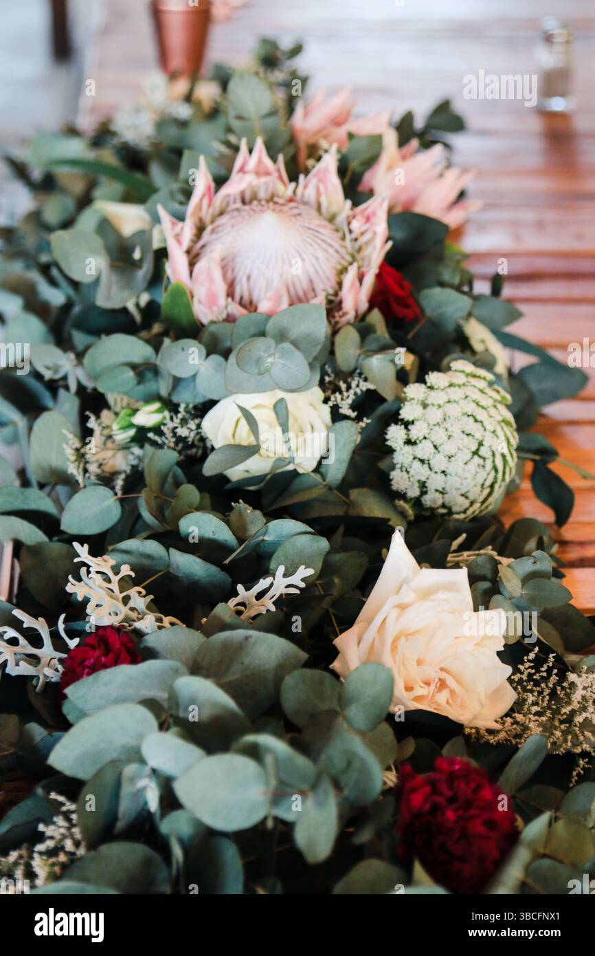 Rose, protea and fynbos table decor Stock Photo - Alamy