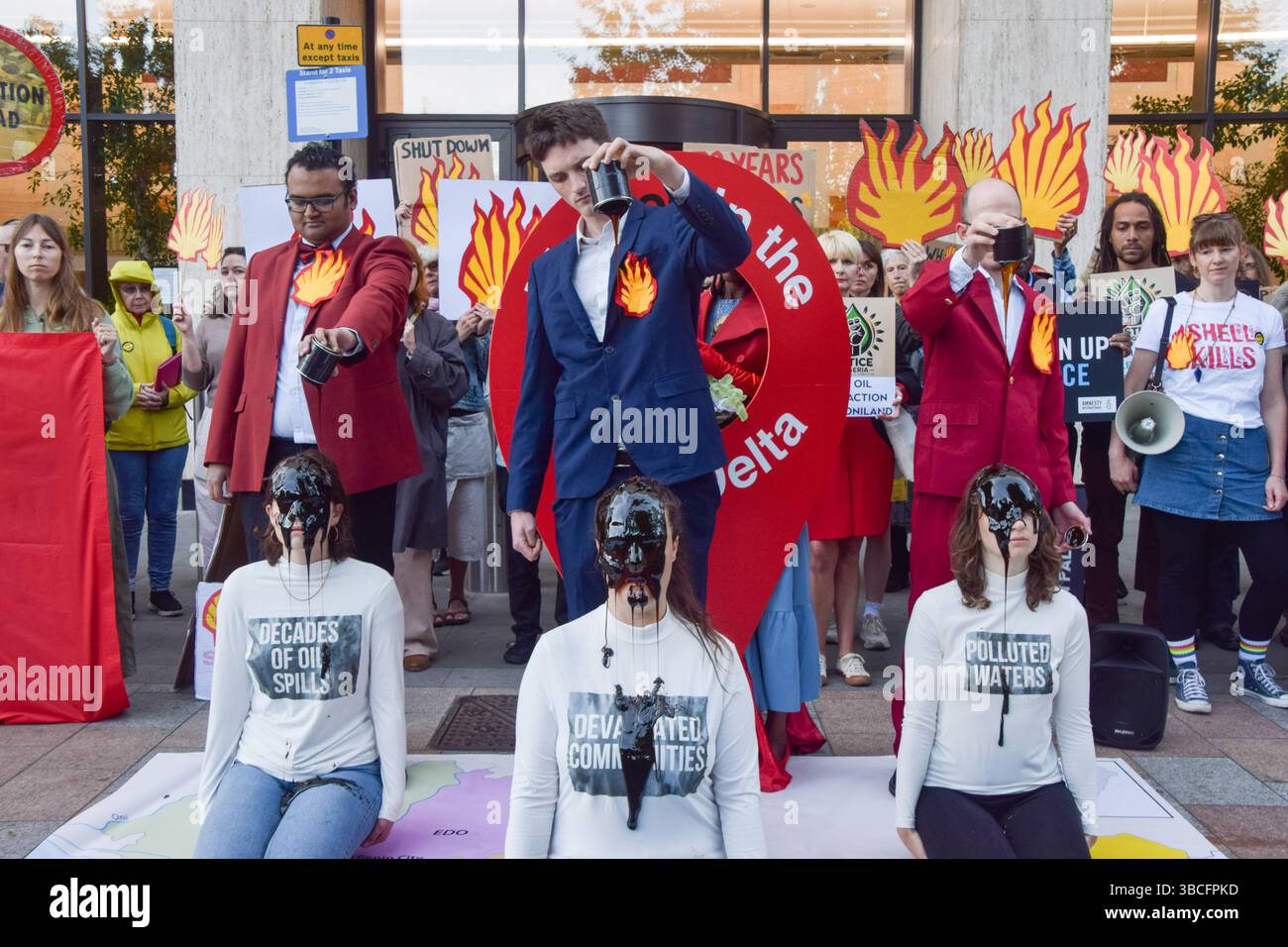 London, UK. 20th May 2025. Environmental activists pour fake oil over ...
