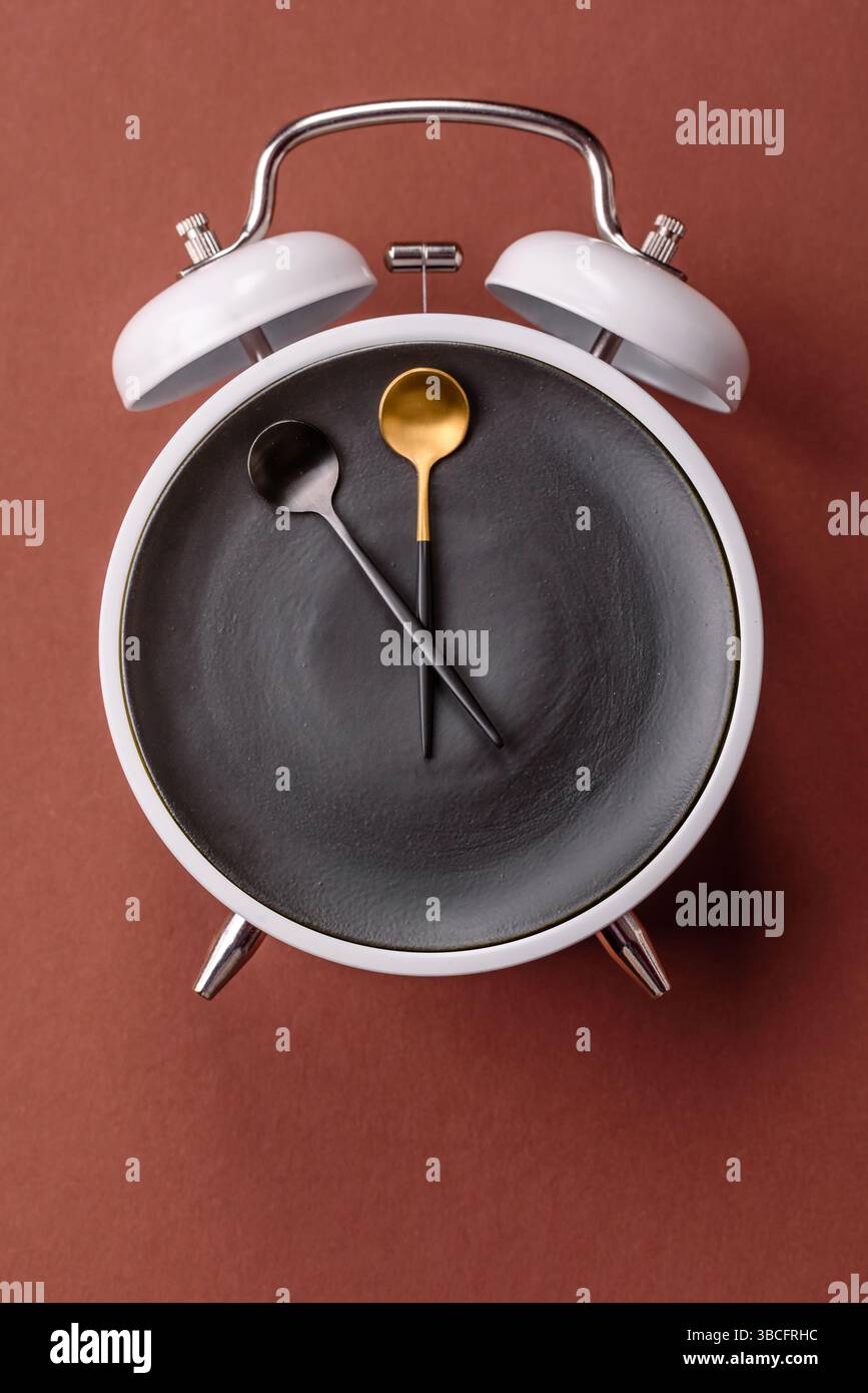 Empty plate with devices in the form of clock hands as a conceptual ...
