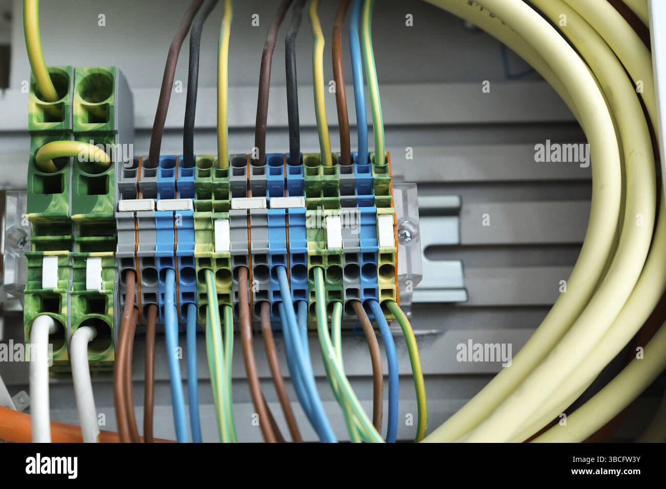 many colorful electrical wires lead into a relay and transformer panel ...
