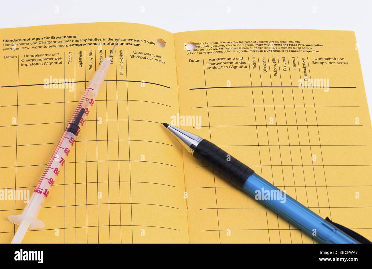 The photo shows a vaccination card with syringe and pen Stock Photo - Alamy