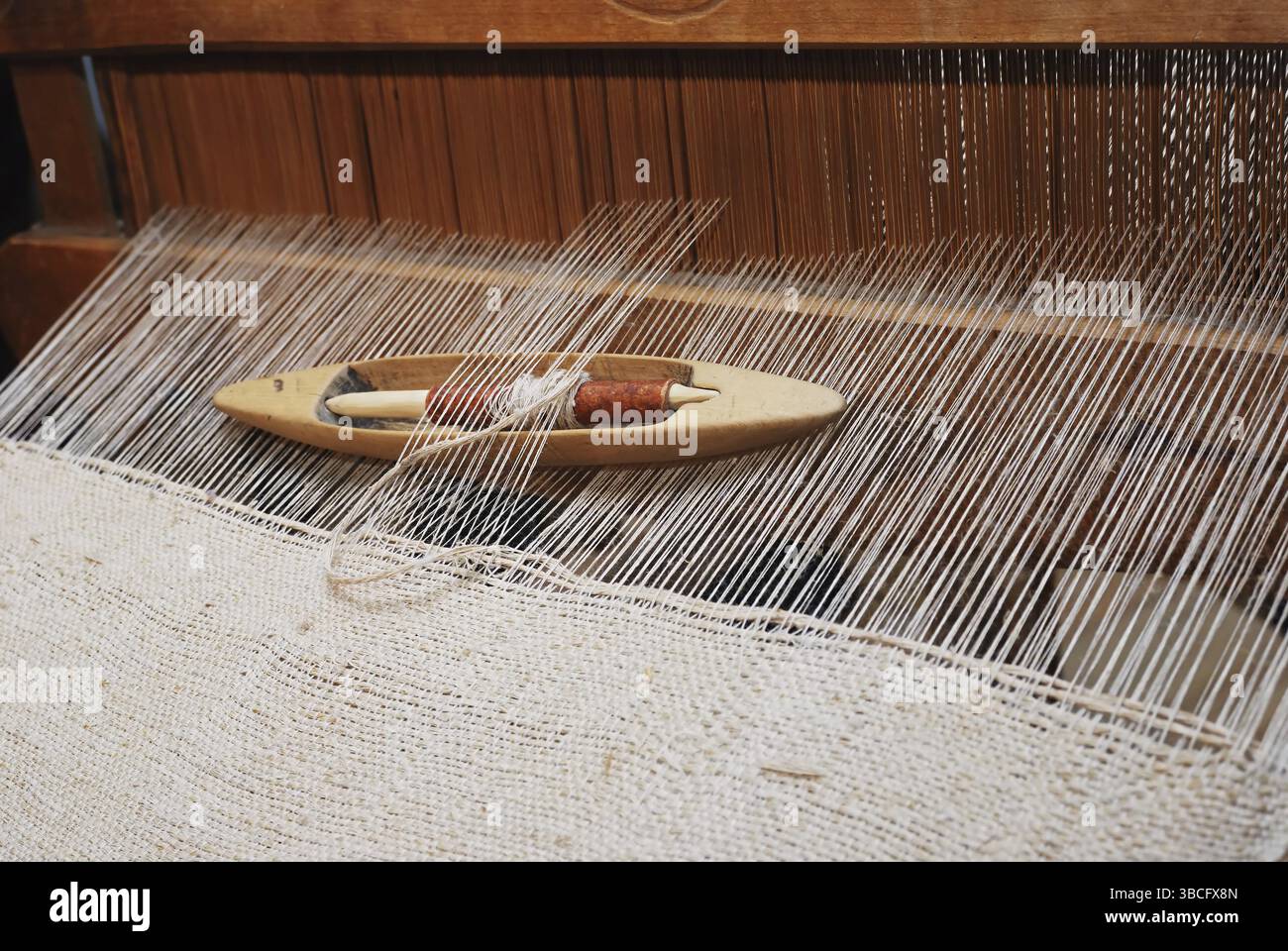 Shuttle on the antique loom and thread Stock Photo - Alamy