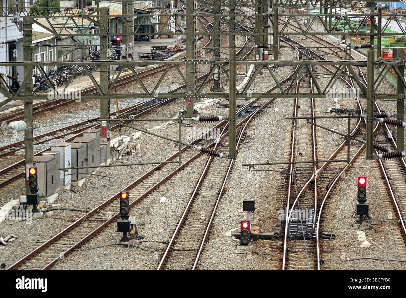 Multiple train tracks, signals and high voltage power lines close to a ...