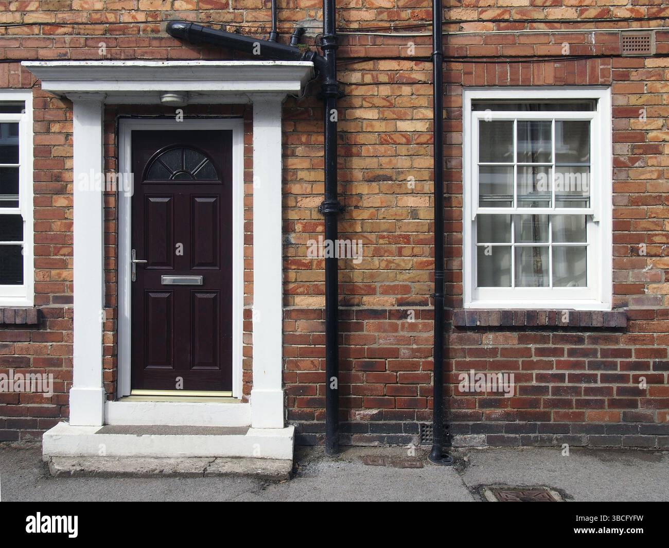 Front view of a typical old small english terraced brick house with ...