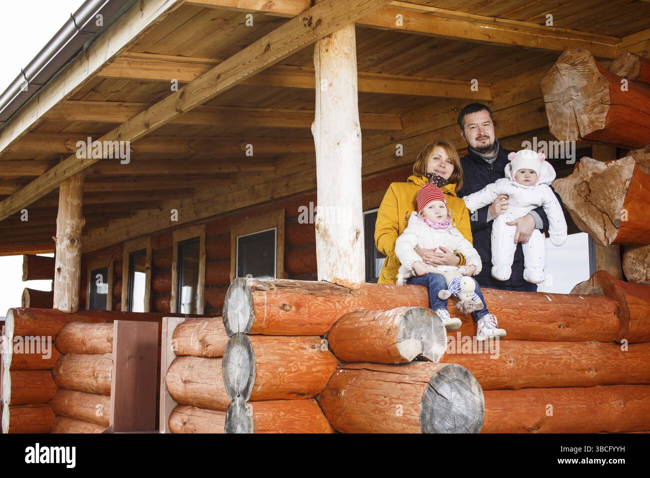 Happy parents with their children countryside on house veranda Stock ...