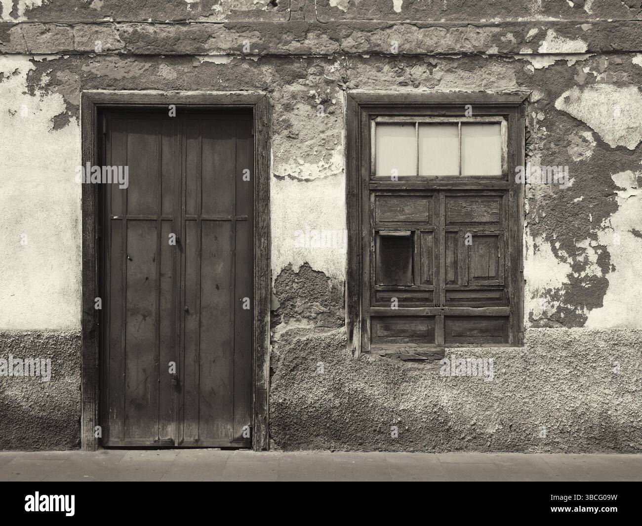 Monochrome image of the front of an old abandoned house with shuttered ...