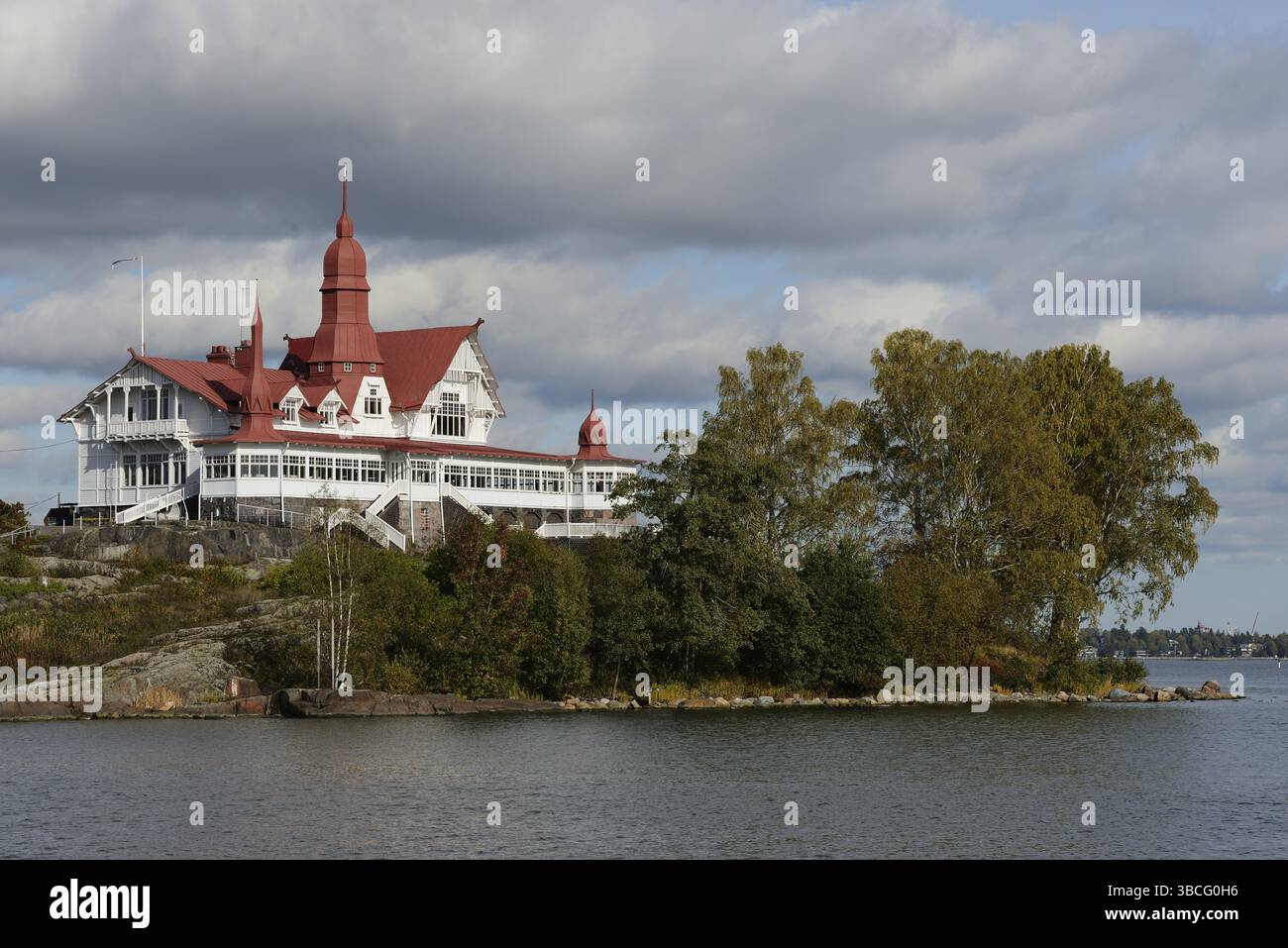 This image captures a historic seaside building with distinctive red ...