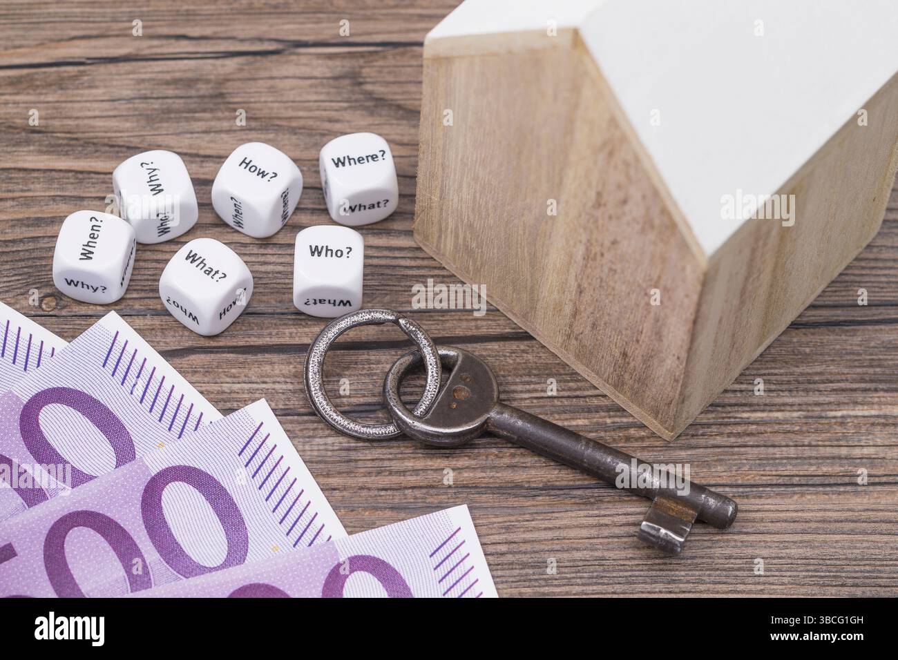 The photo shows a model house with various question cubes and a key ...