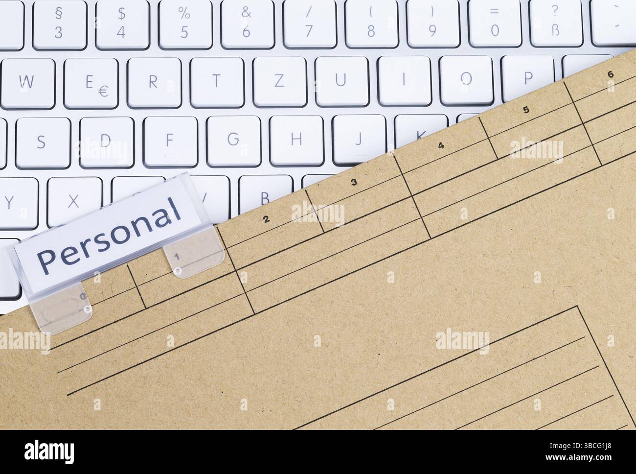 The photo shows a white keyboard with a personnel file Stock Photo - Alamy
