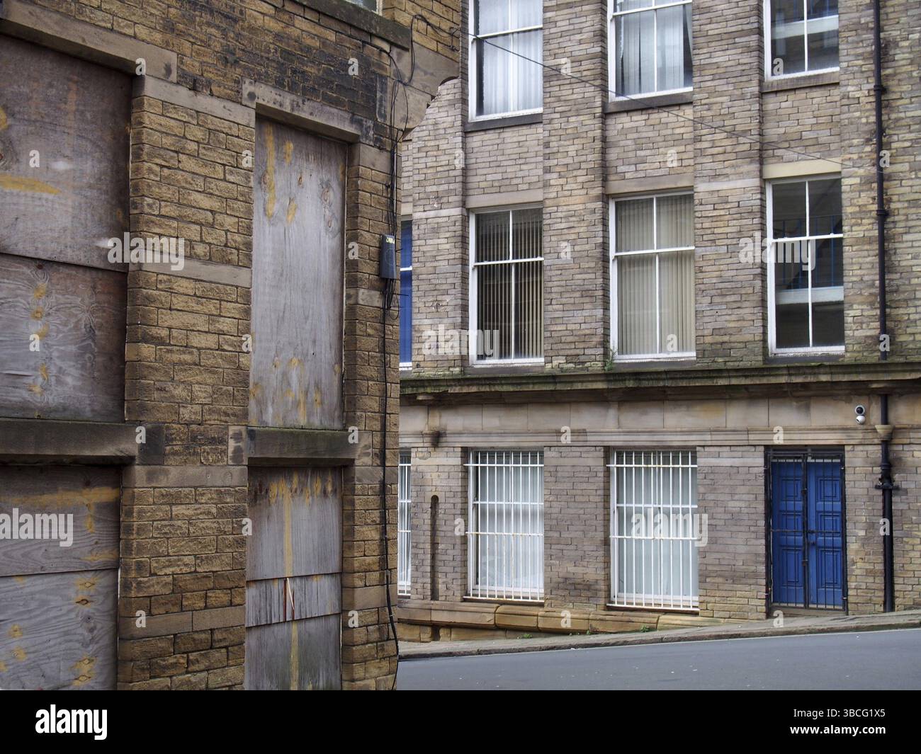 A street corner view of closed and boarded up old abandoned industrial ...