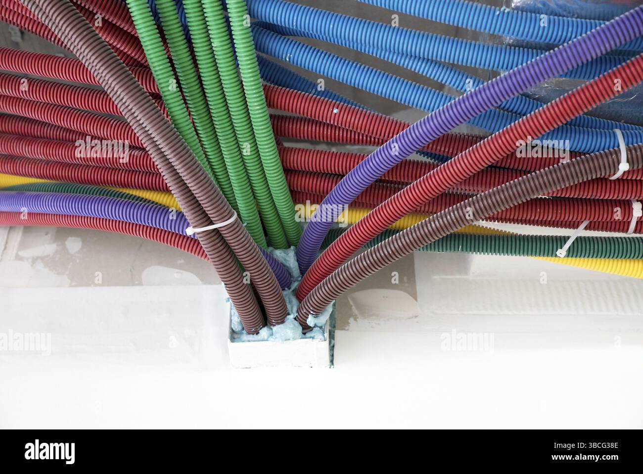 colorful plastic tubes for electrical wires in the sub ceiling in a ...