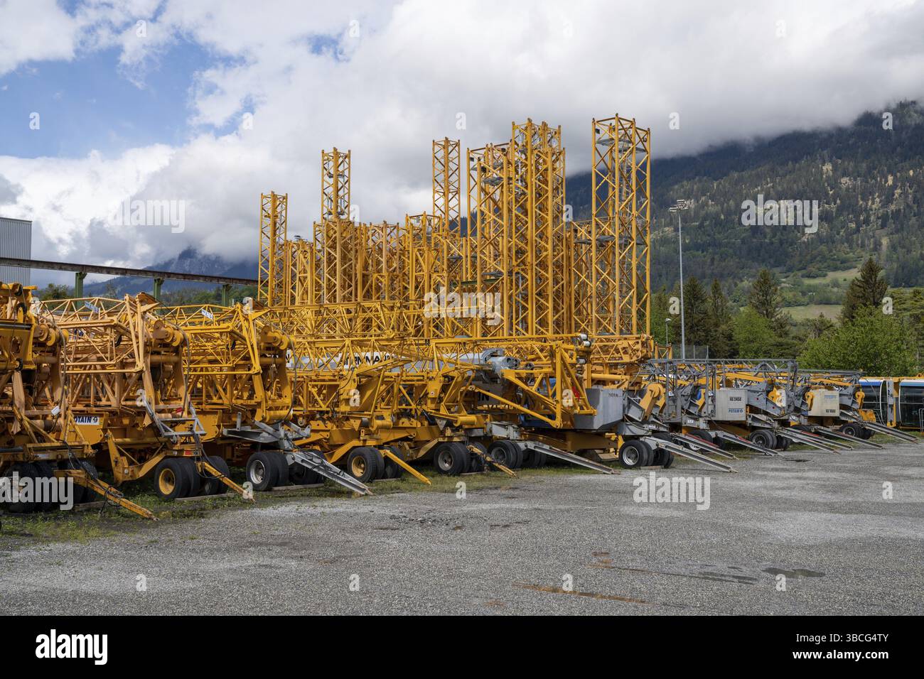 A view of many industrial cranes ready to be installed on construction ...