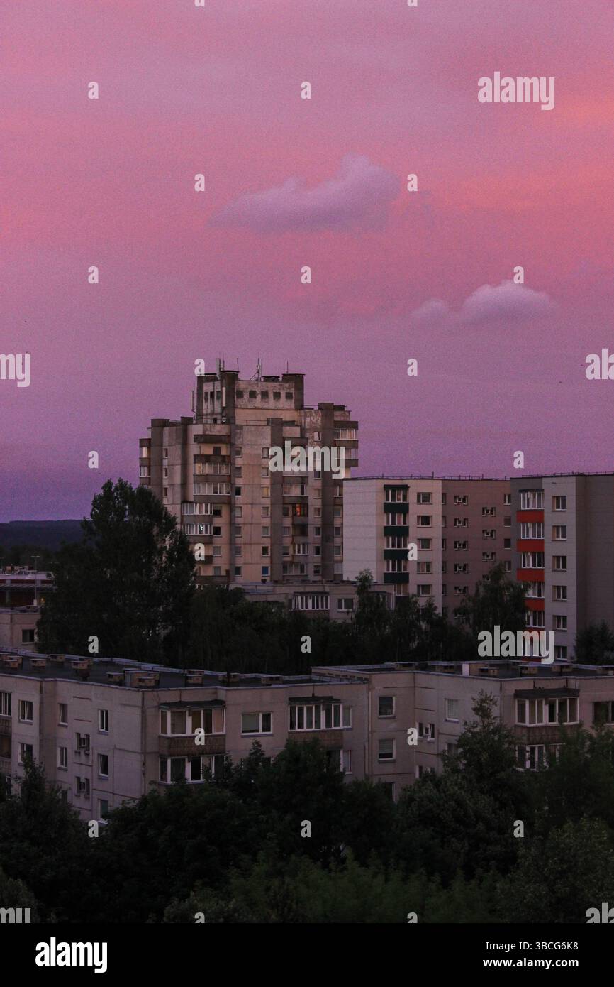 Soviet-era apartment buildings under a pastel violet-pink dusk sky in ...