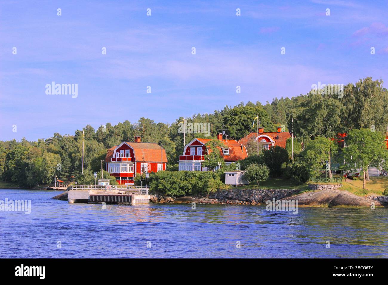 Traditional red wooden houses with waterfront piers in the Stockholm ...