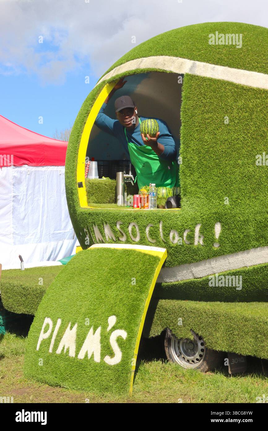 A bartender read to serve a gin based fruit cup liqueur from a ...