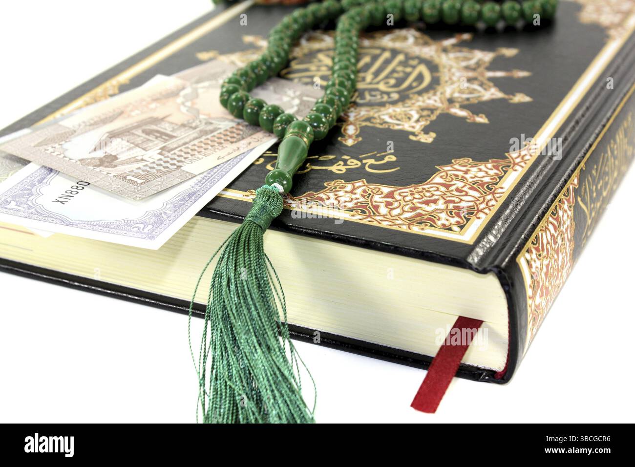 Closed Koran with Pakistani rupee against a light background Stock ...